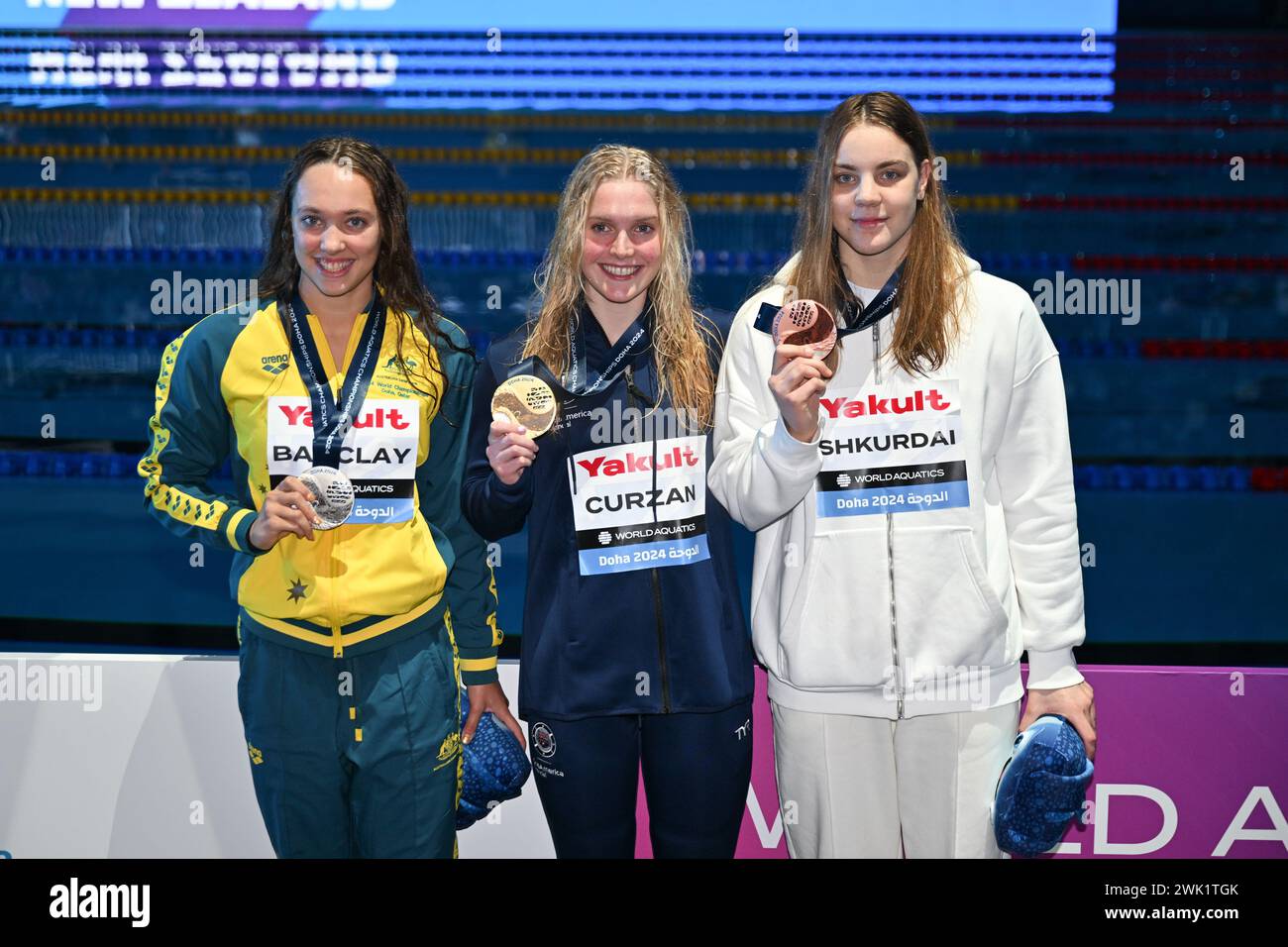 Doha, Qatar. 17th Feb, 2024. Gold medalist Claire Curzan (C) of the ...