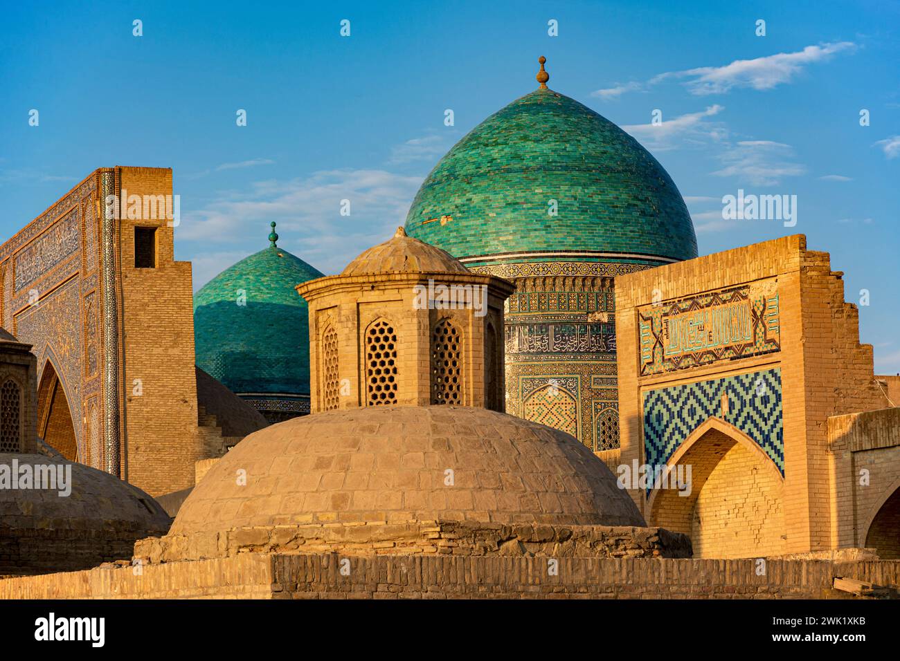 The green domes in Mir i Arab (Emir Alim Khan) Madrasa in Bukhara evoke ...