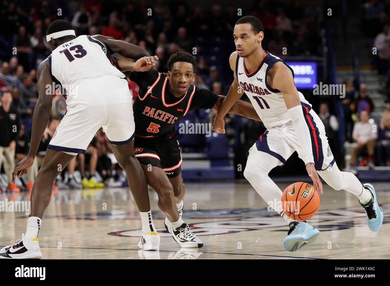 Gonzaga guard Nolan Hickman (11) drives as Gonzaga forward Graham Ike ...