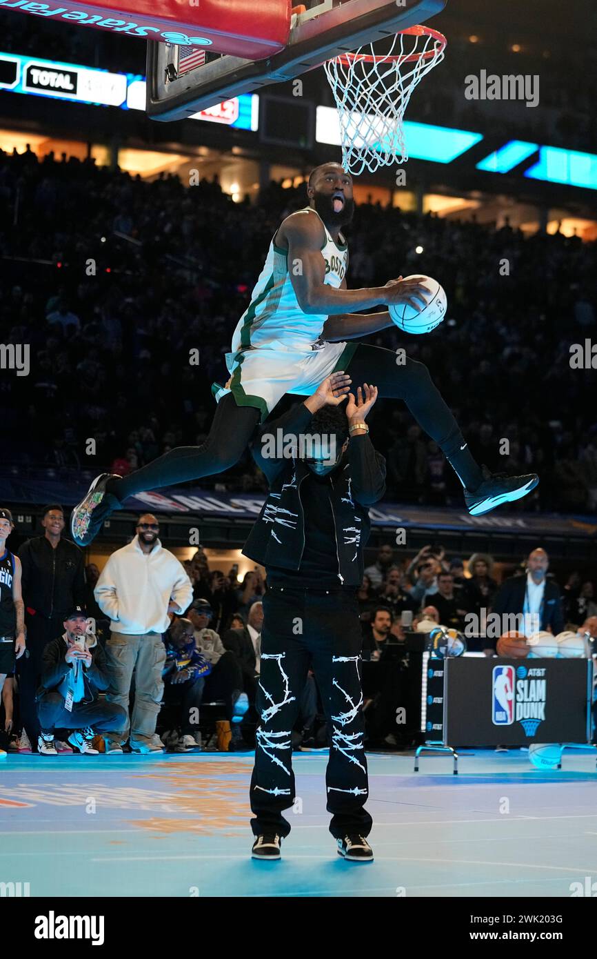 Boston Celtics' Jaylen Brown dunks over Donovan Mitchell during the ...