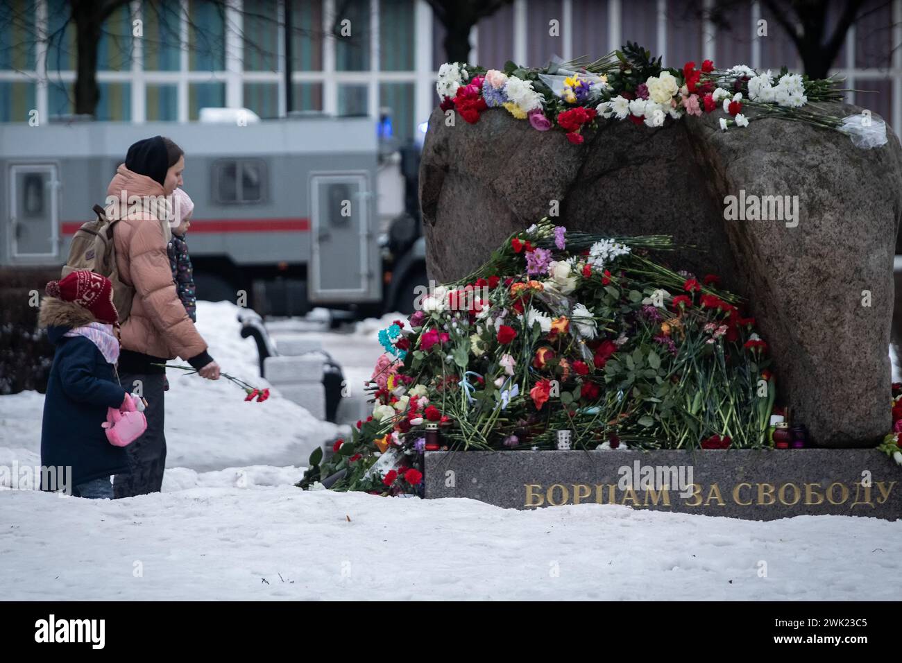A mother and children lay flowers at a spontaneous memorial in memory ...