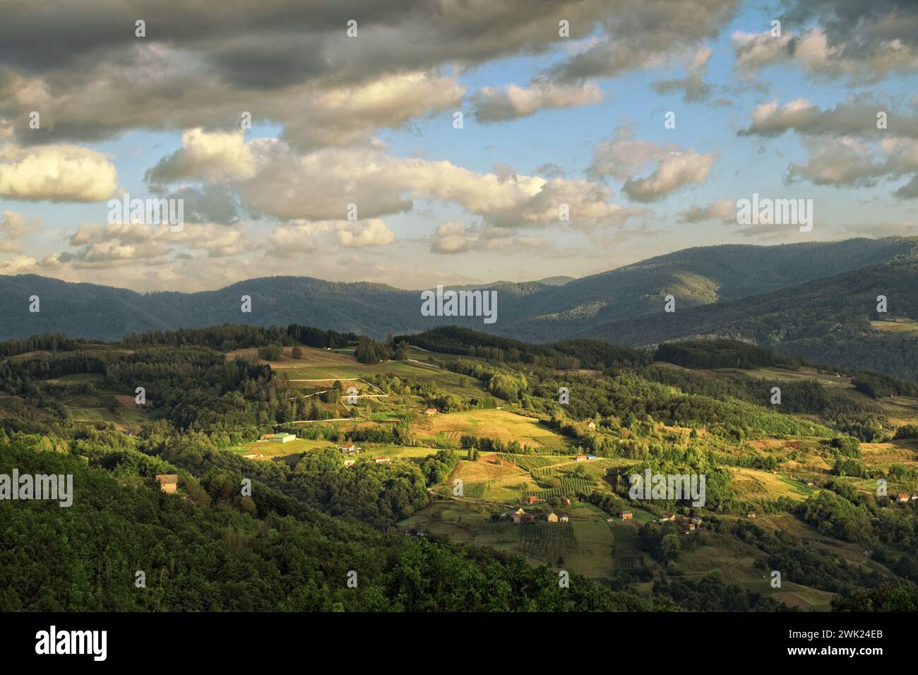 houses scattered in the beautiful countryside in light and shadow below ...