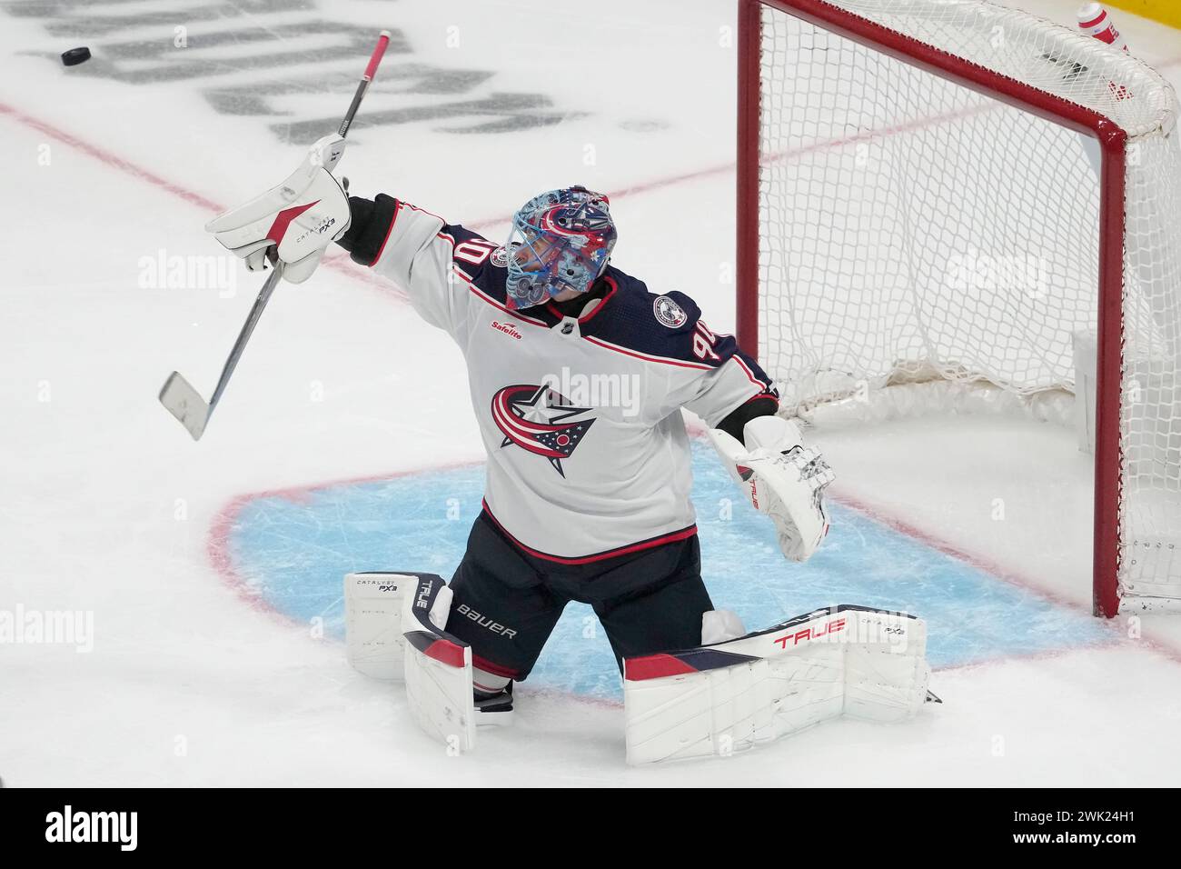 Columbus Blue Jackets goaltender Elvis Merzlikins deflects a San Jose ...