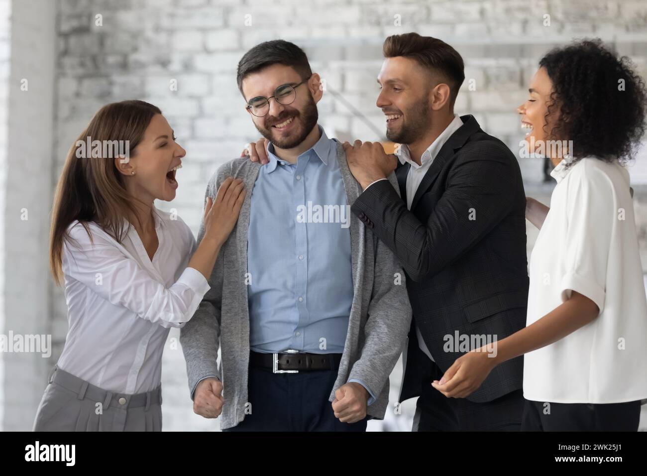 Company employees are happy for success of their coworker Stock Photo ...