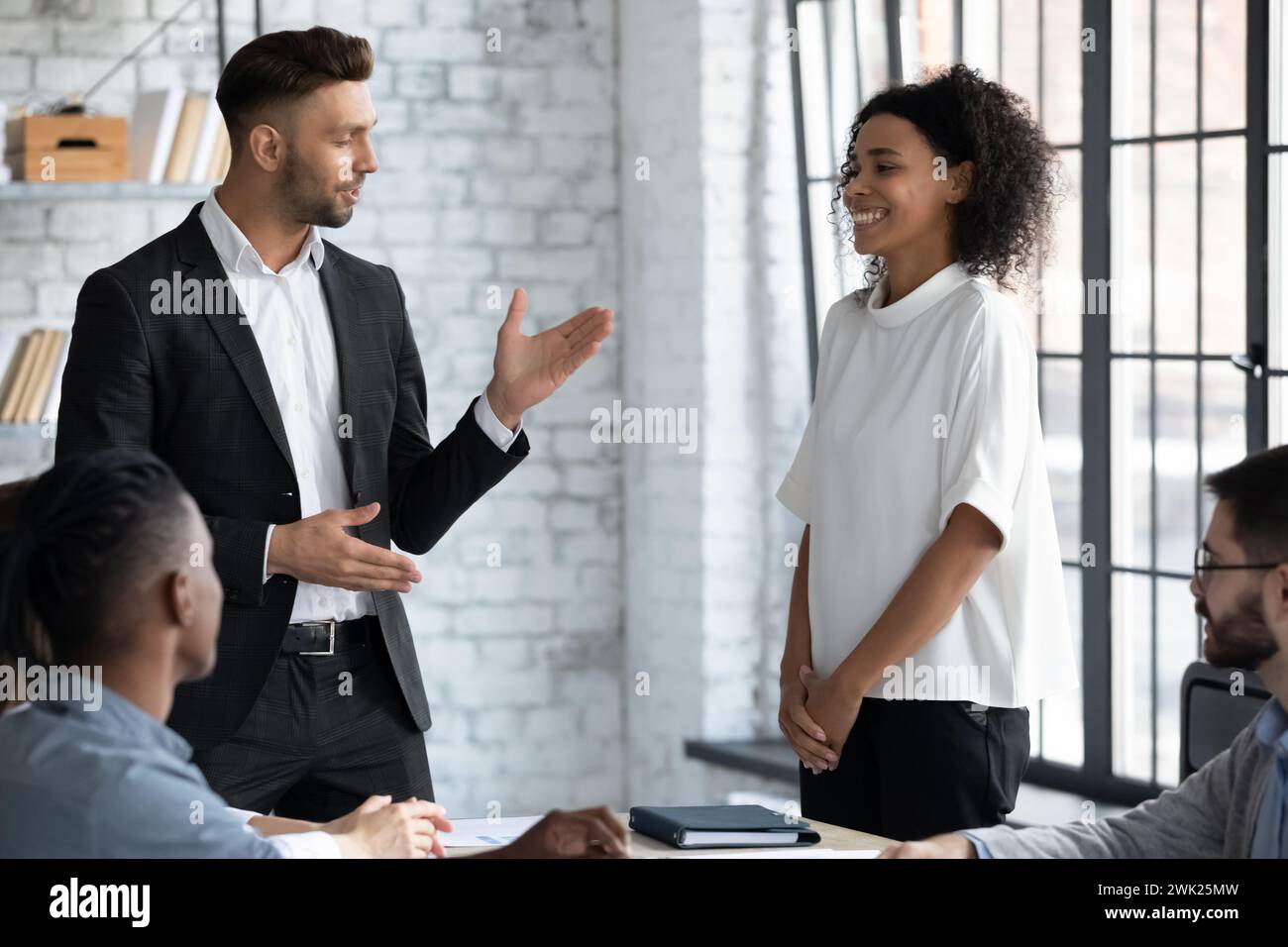 Satisfied executive giving positive feedback on work of company ...