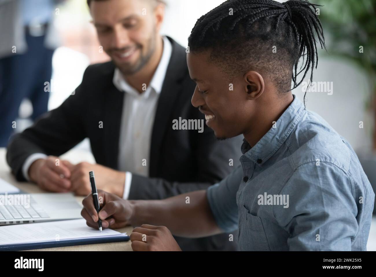 African american new hire signing hi-res stock photography and images ...