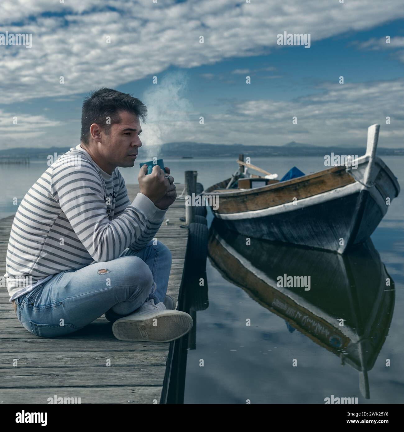 Man sitting on dock hi-res stock photography and images - Alamy