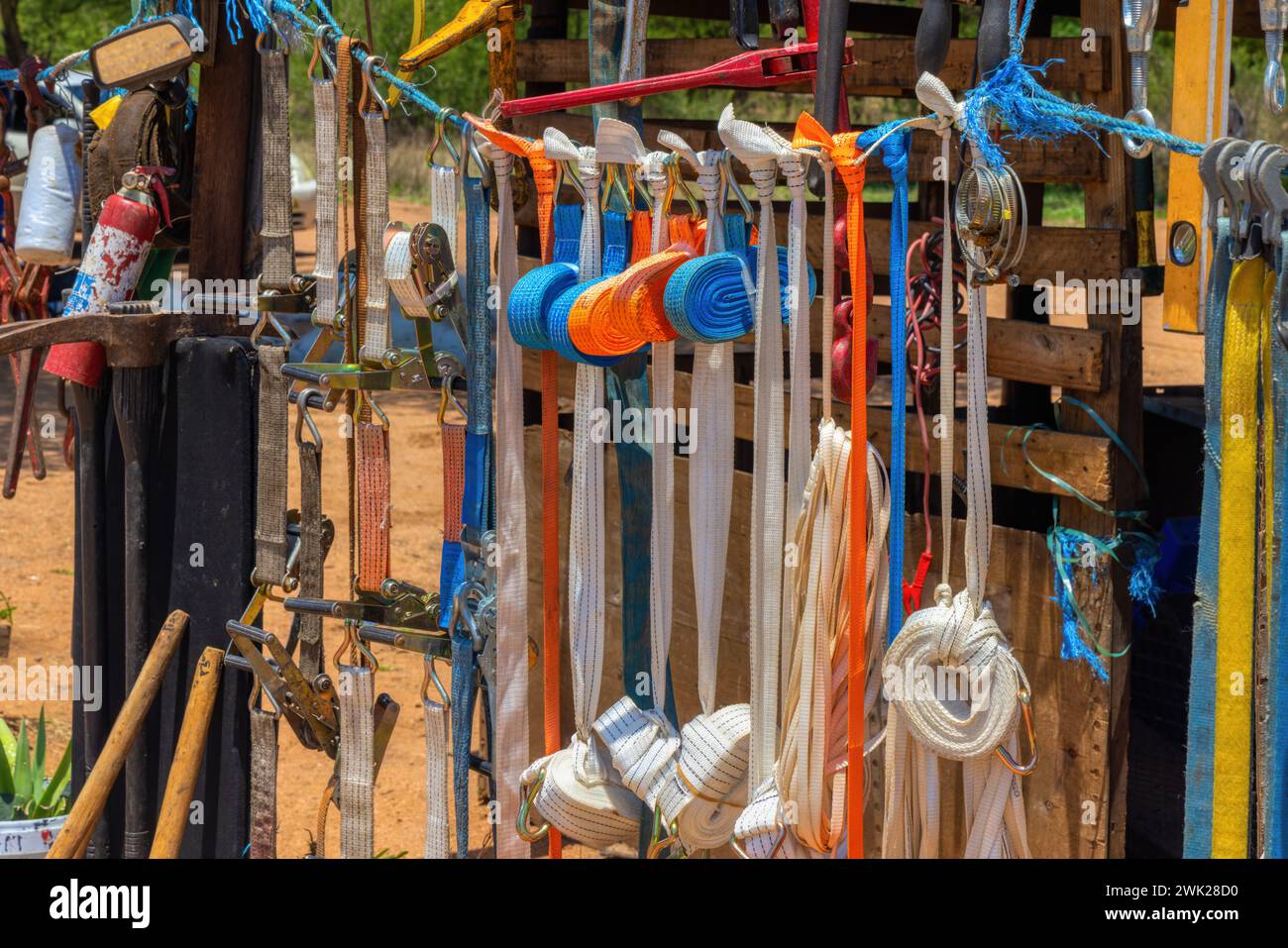 street vendor hardware shop on the side of the road with various goods ...