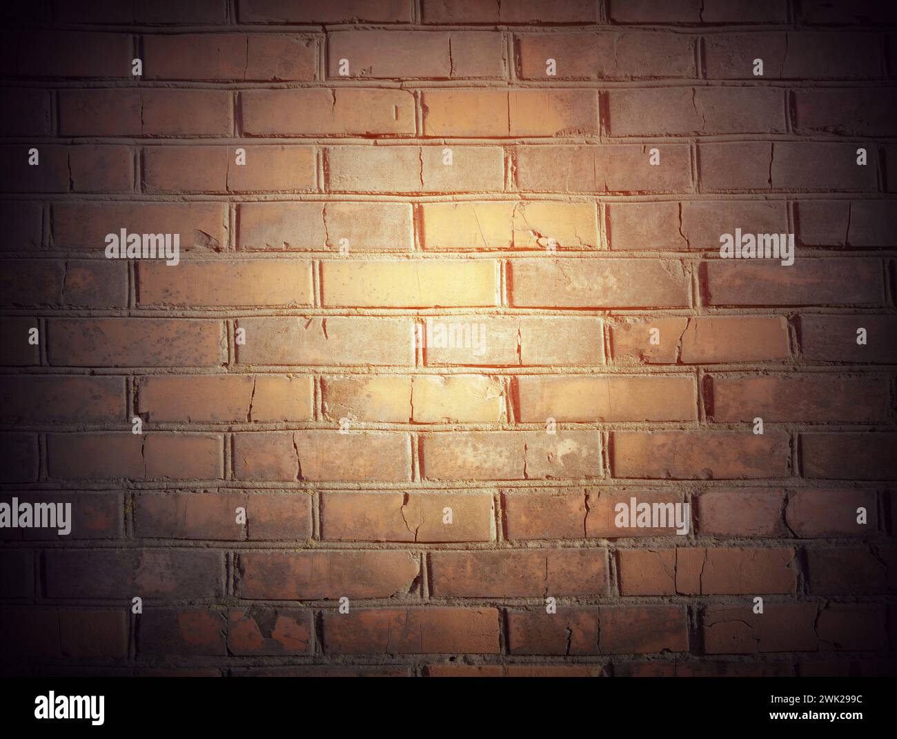 abstract old brick wall in the dark with spotlight warm light tone ...