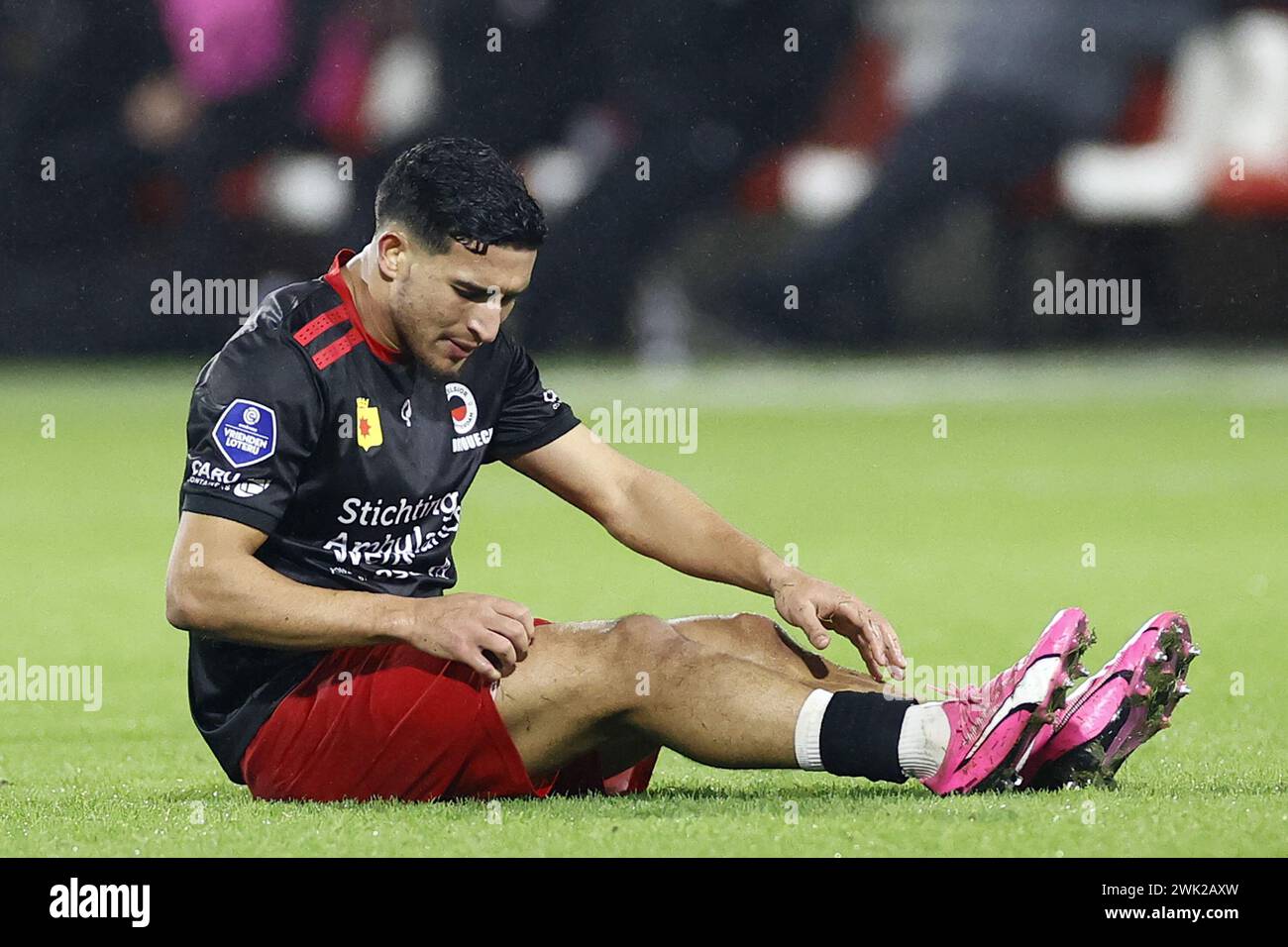 ROTTERDAM - Couhaib Driouech of Excelsior sits on the ground injured ...