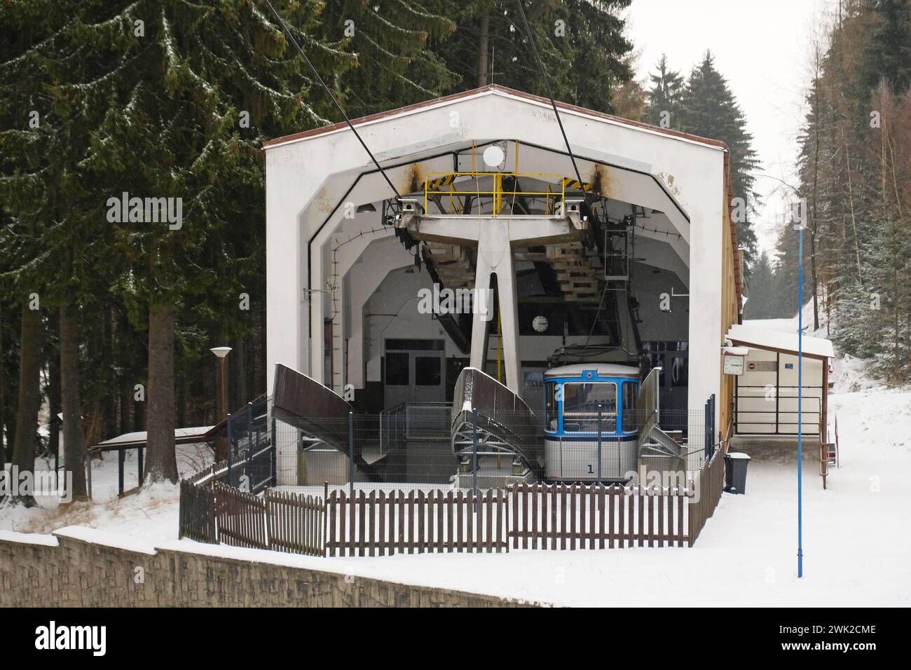 The ski lift is located amidst a snowy forest landscape Stock Photo - Alamy