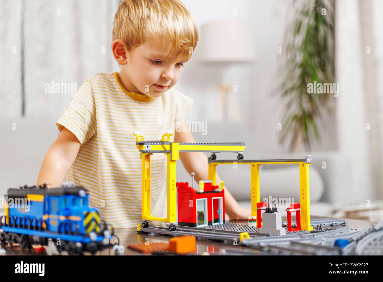 Boy Playing with Toy Train and Construction Set Stock Photo - Alamy