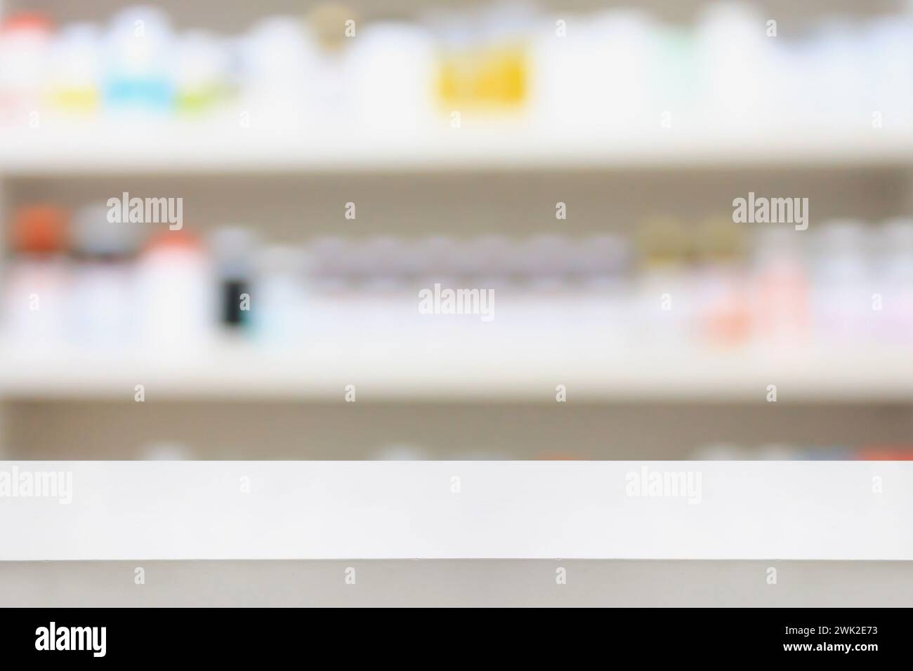 Blank white pharmacy table counter with blur shelves of drug in the ...