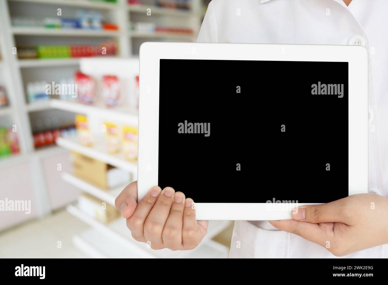 pharmacist showing promotion displaying the blank screen of tablet ...