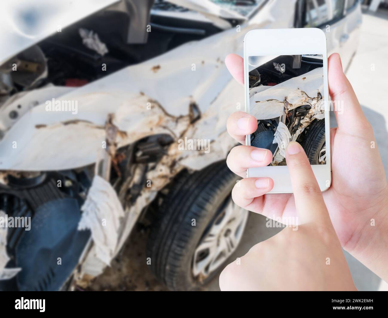 Female using mobile smart phone taking photo of the car crash accident ...