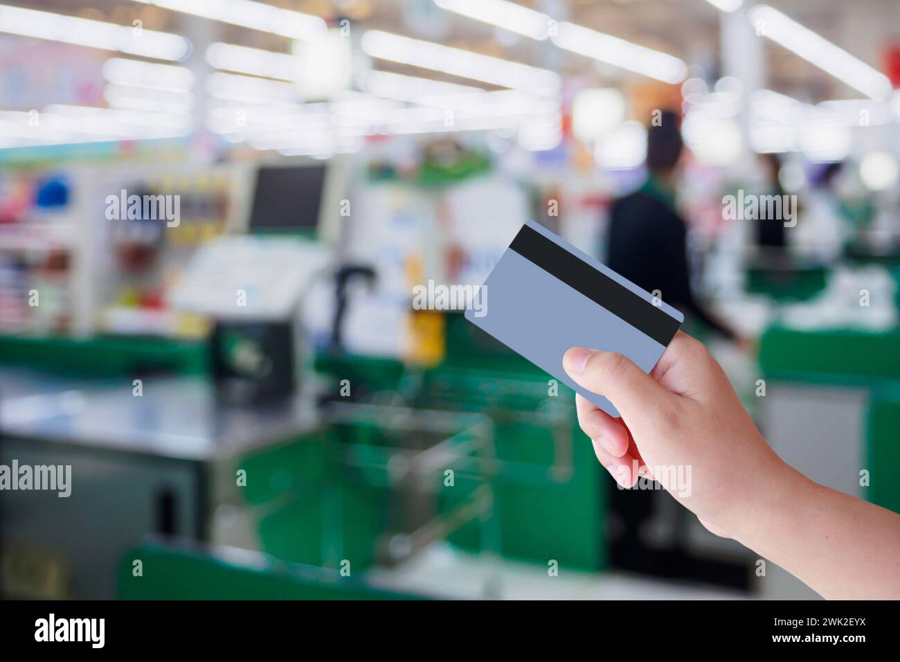 paying using credit card at supermarket checkout cashier counter in ...