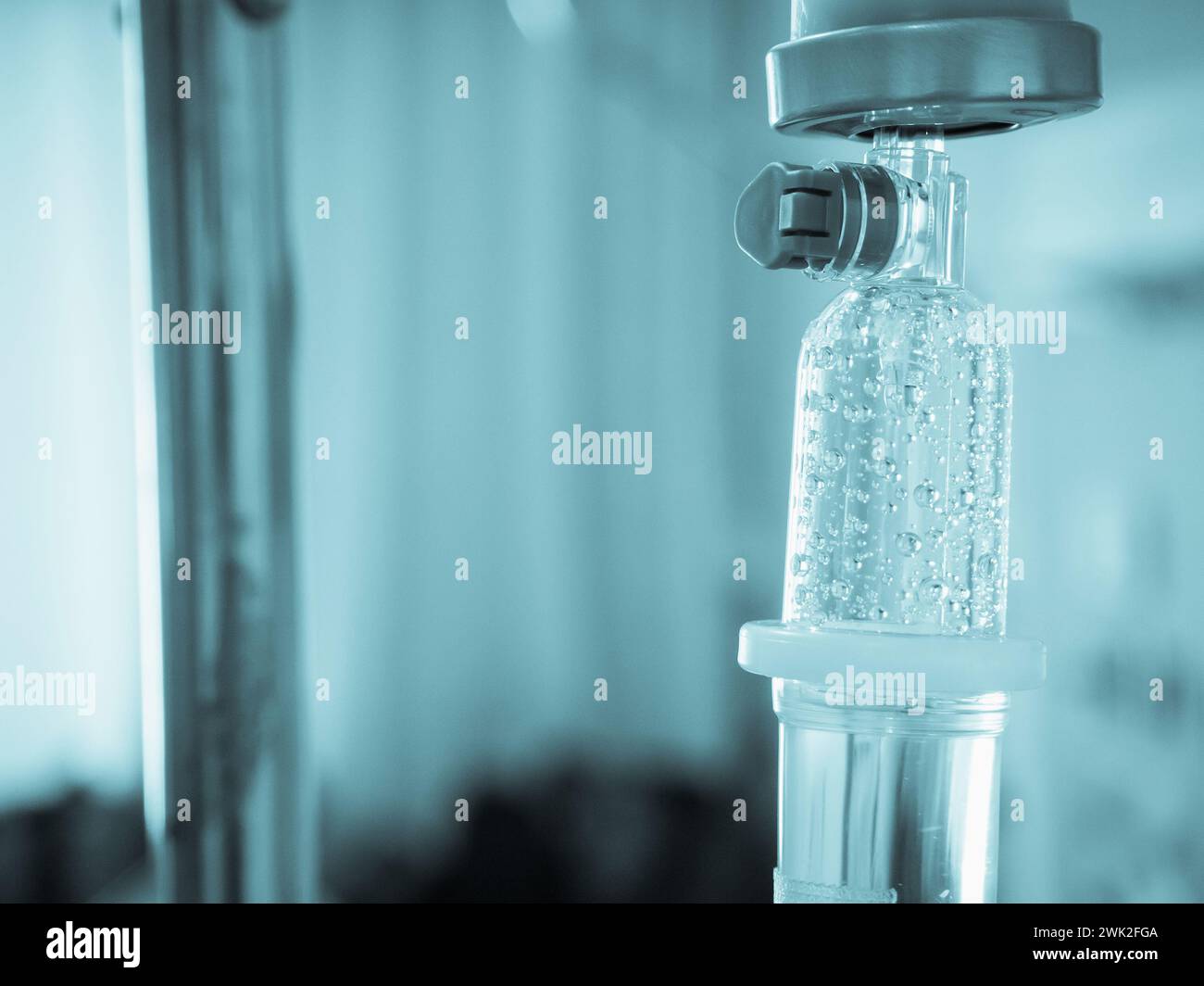 Medical drip with hospital blurred background Stock Photo - Alamy