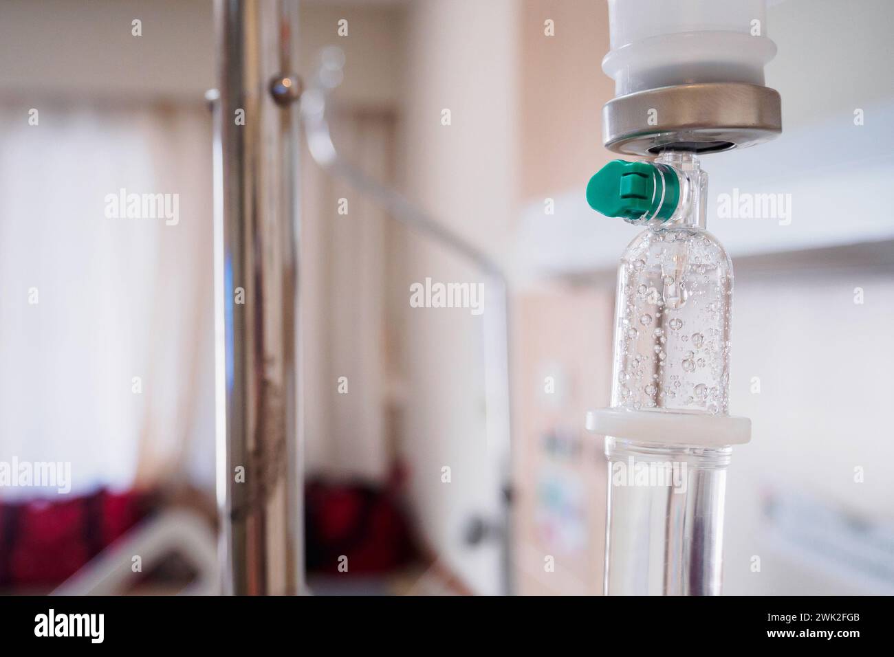 Medical drip with hospital blurred background Stock Photo - Alamy
