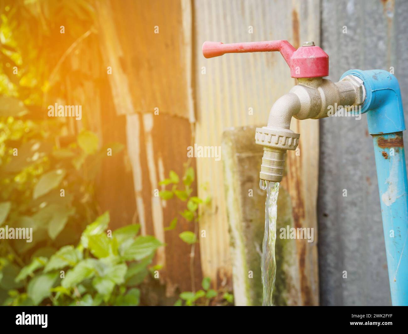 Water tap with water flow Stock Photo - Alamy