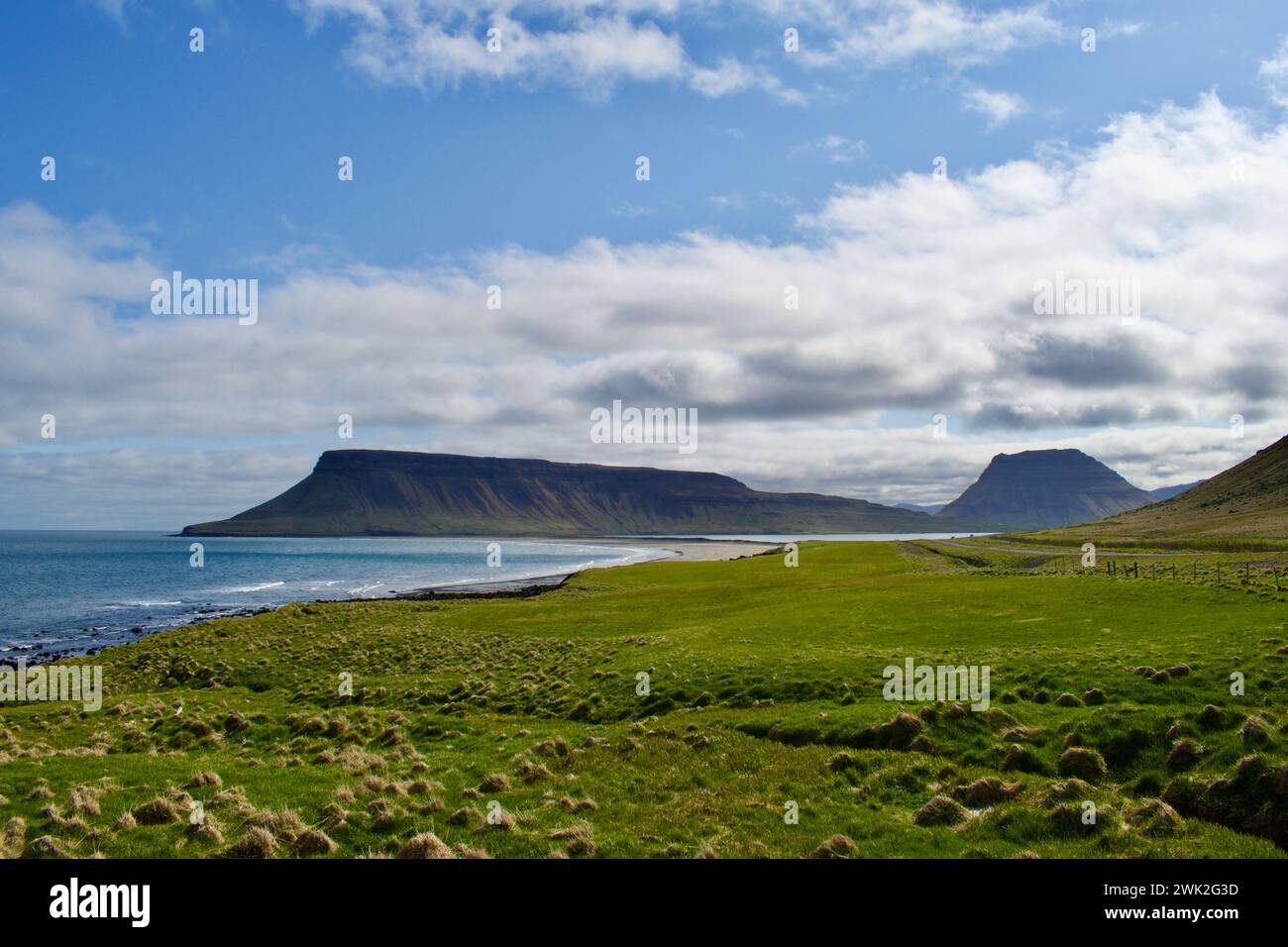 Black sand beach with rocks and reflexes in ring road in Iceland with ...