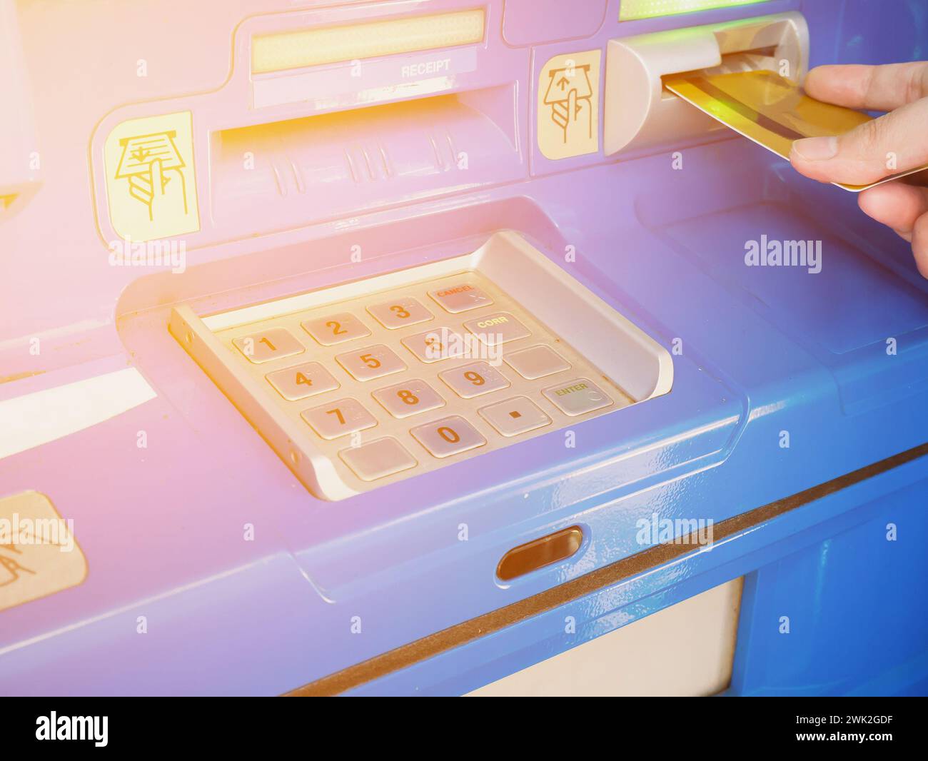 female hand inserting ATM card into ATM bank machine to withdraw money ...