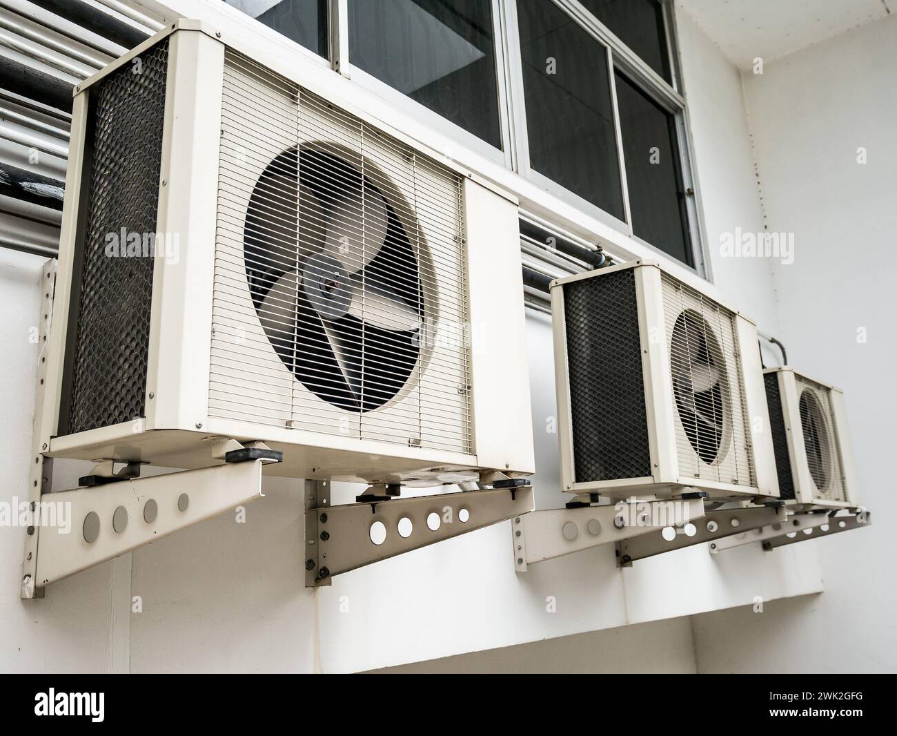 Air conditioner compressor unit installed outdoor in the old building ...