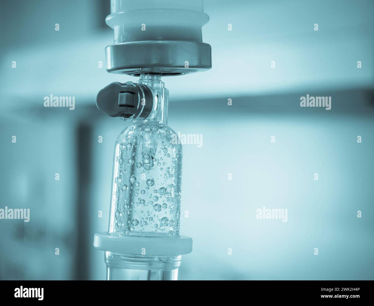 Medical drip with hospital blurred background Stock Photo - Alamy