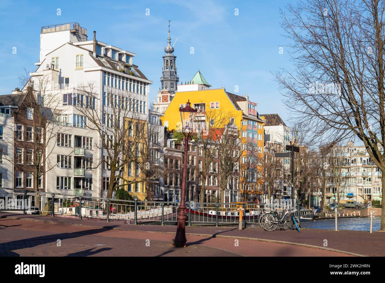 Colorful modern residential buildings along the canal with the tower of ...