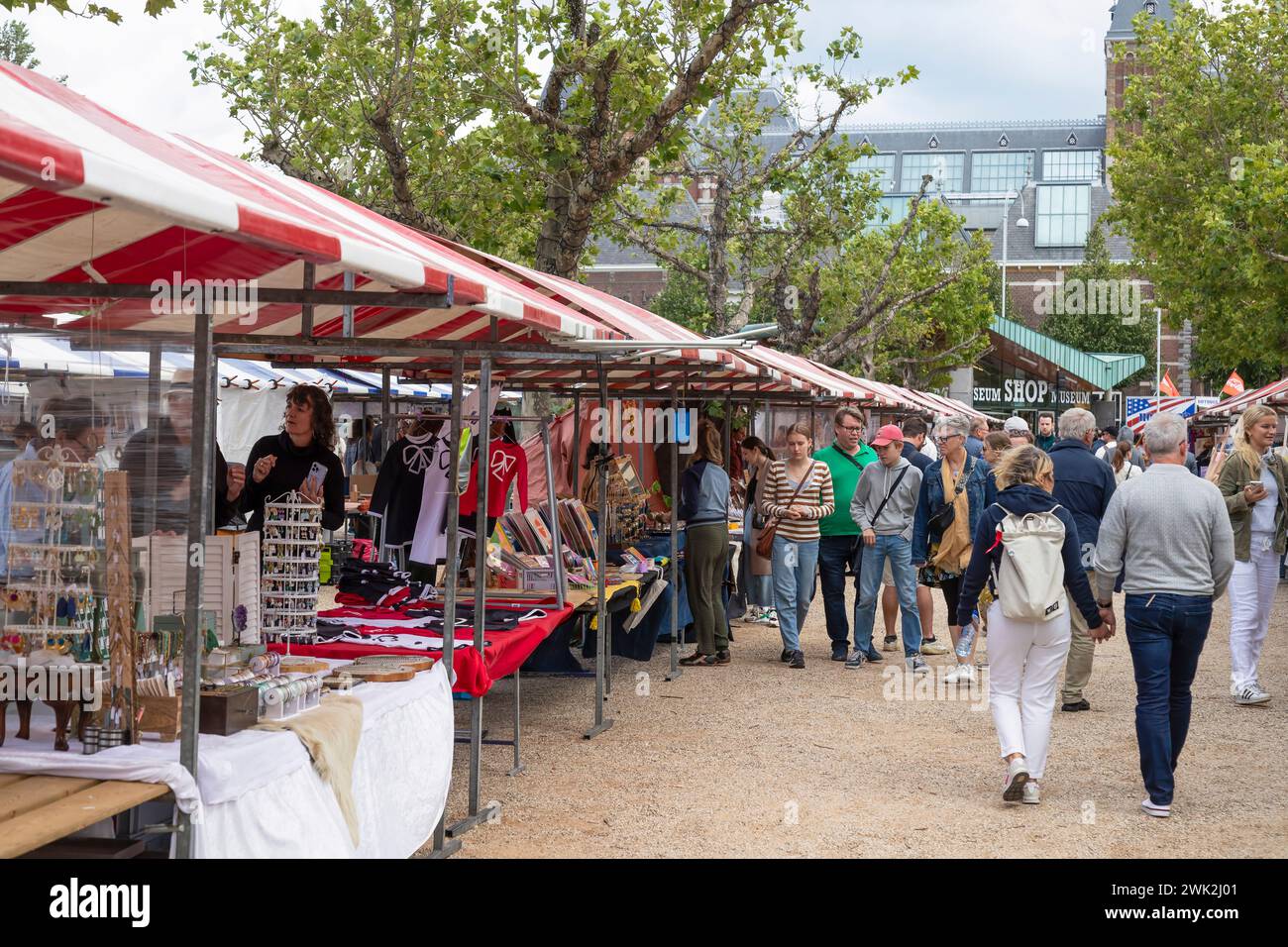 People walk past the market stalls on the museum square in Amsterdam ...