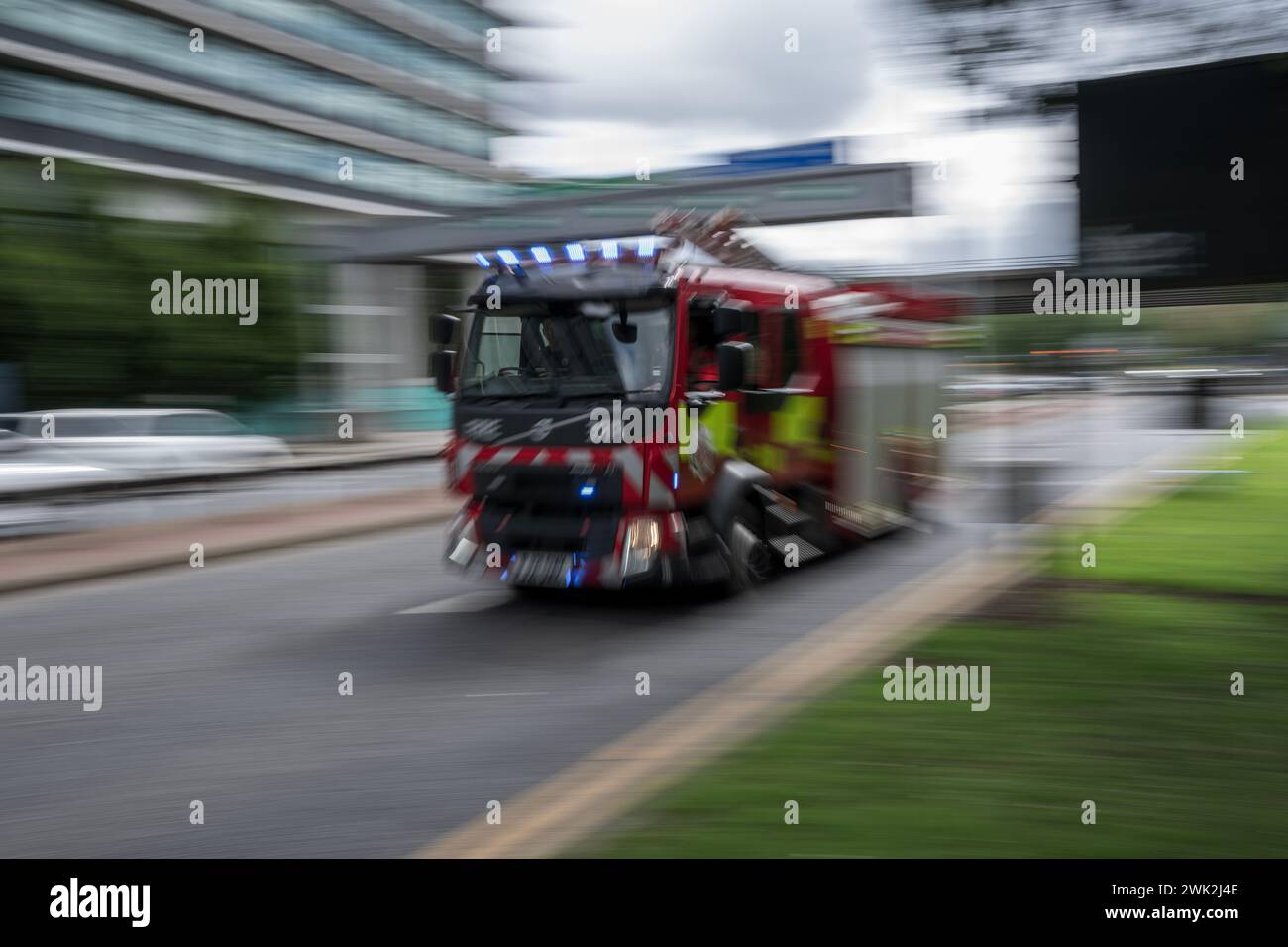 Fire engine on an emergency call travelling at speed in Manchester city ...