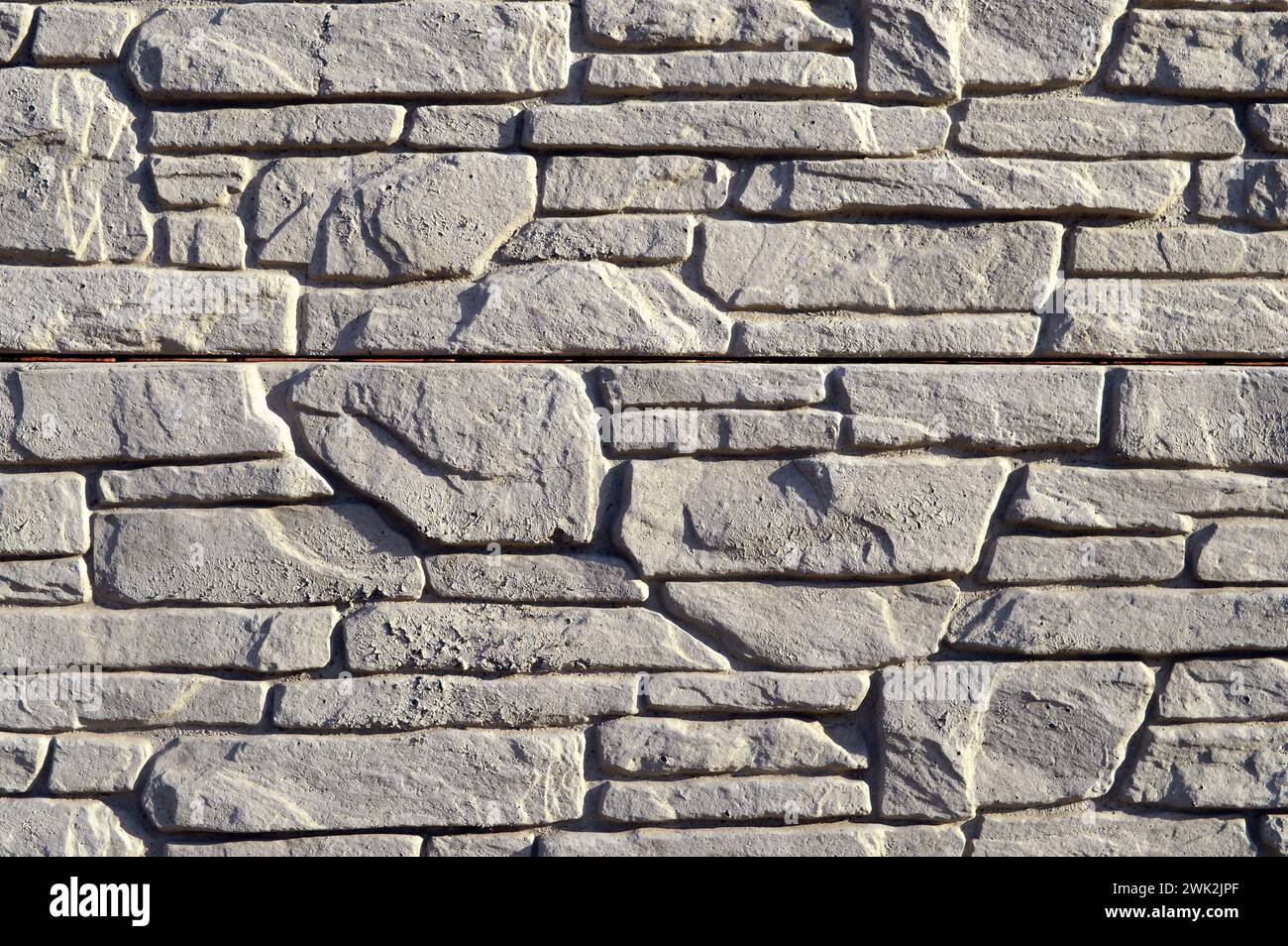 Textured stone walls built of large rough stones held together by lumps ...