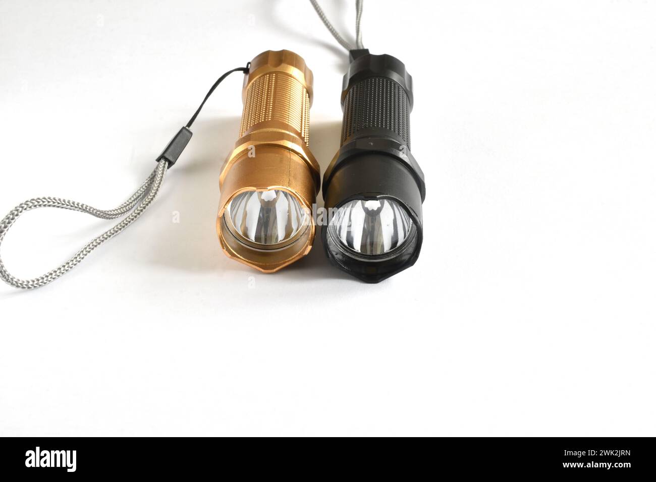 Two hand-held flashlights of the same design, but of different colors ...