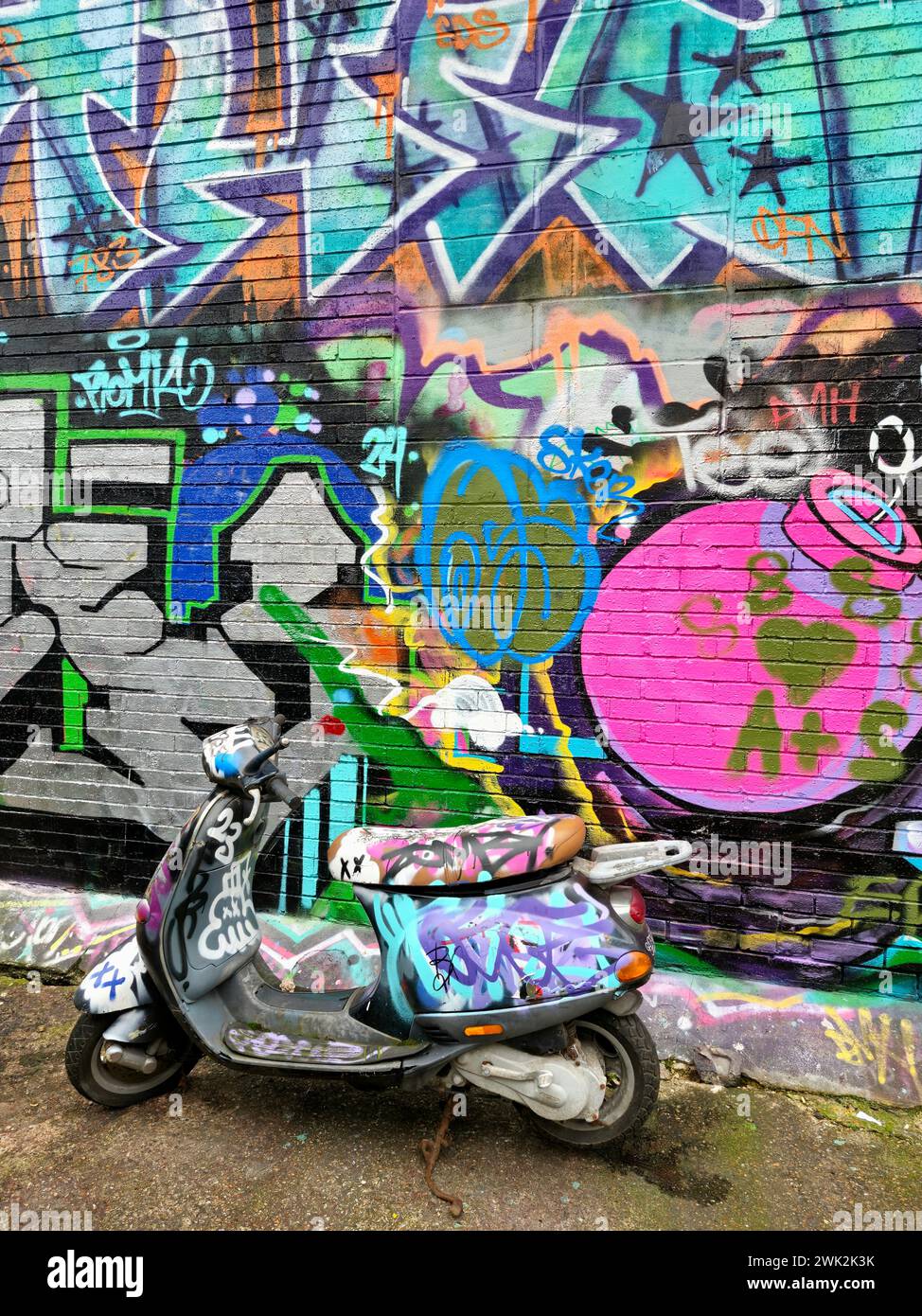 Graffiti wall and abandoned scooter in Shoreditch, East London Stock ...