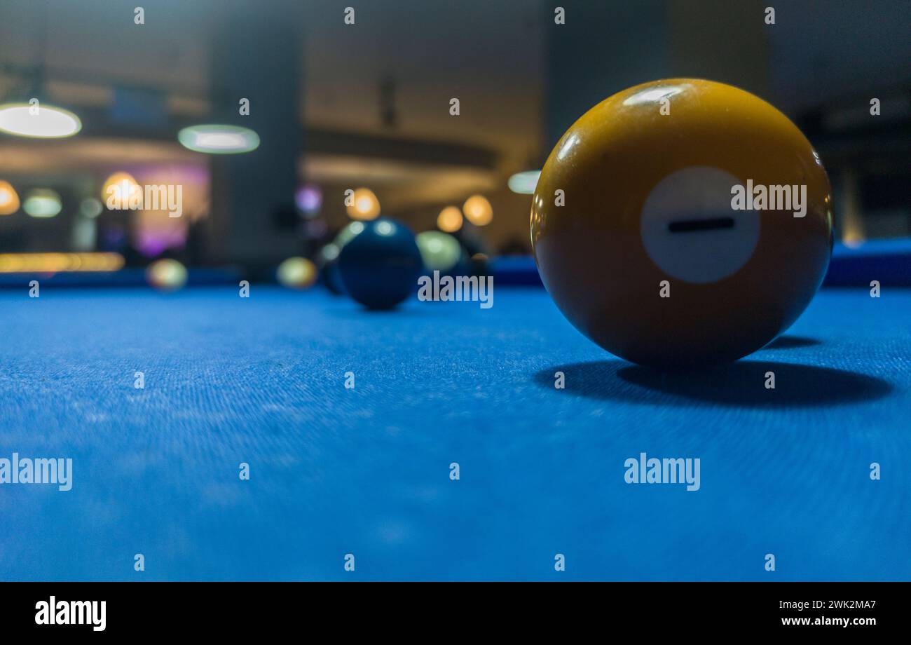 Yellow solid ball. Eight-ball pool game at six pocket blue table Stock ...