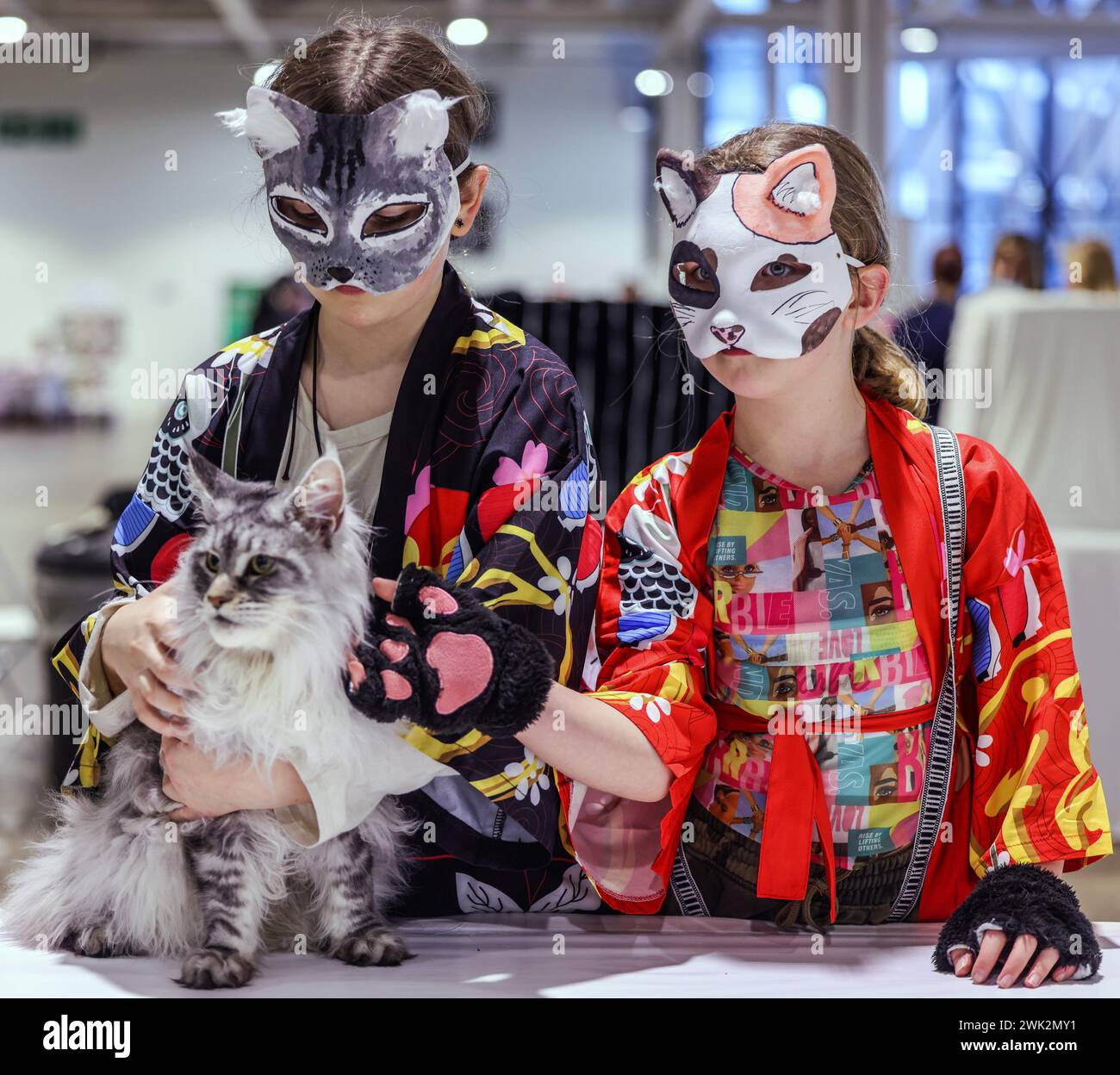 Olympia London 18 Feb 2024 Clara and Celia with their cat fluff at a ...