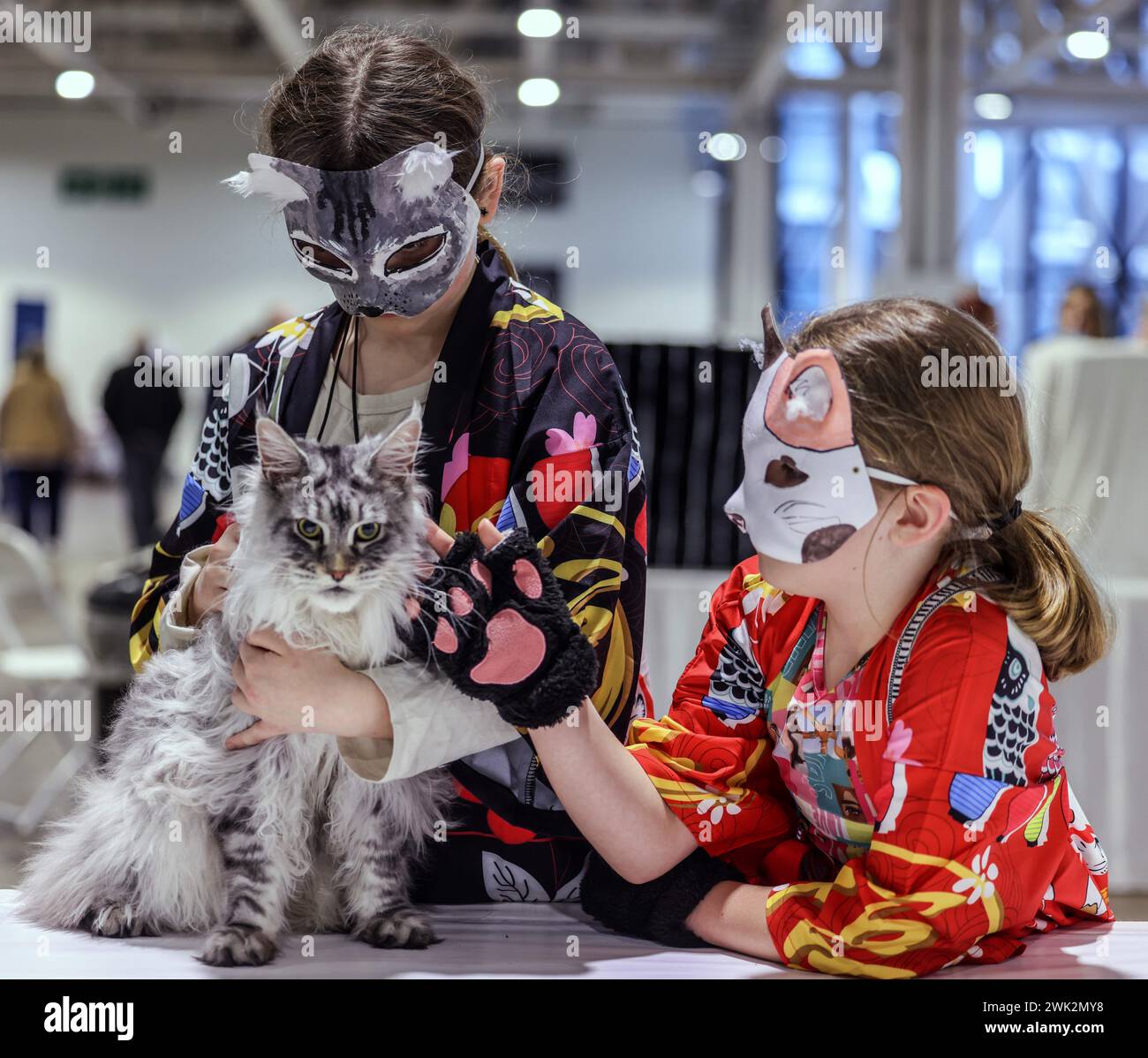 Olympia London 18 Feb 2024 Clara and Celia with their cat fluff at a ...