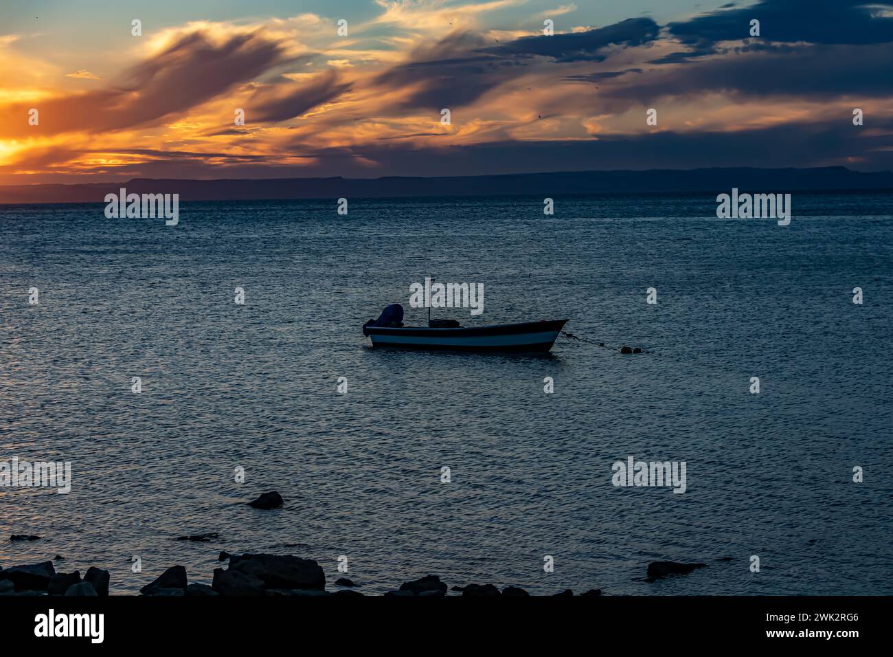 Mexican coastal sunset, motor boat anchored on calm waters of Sea of ...