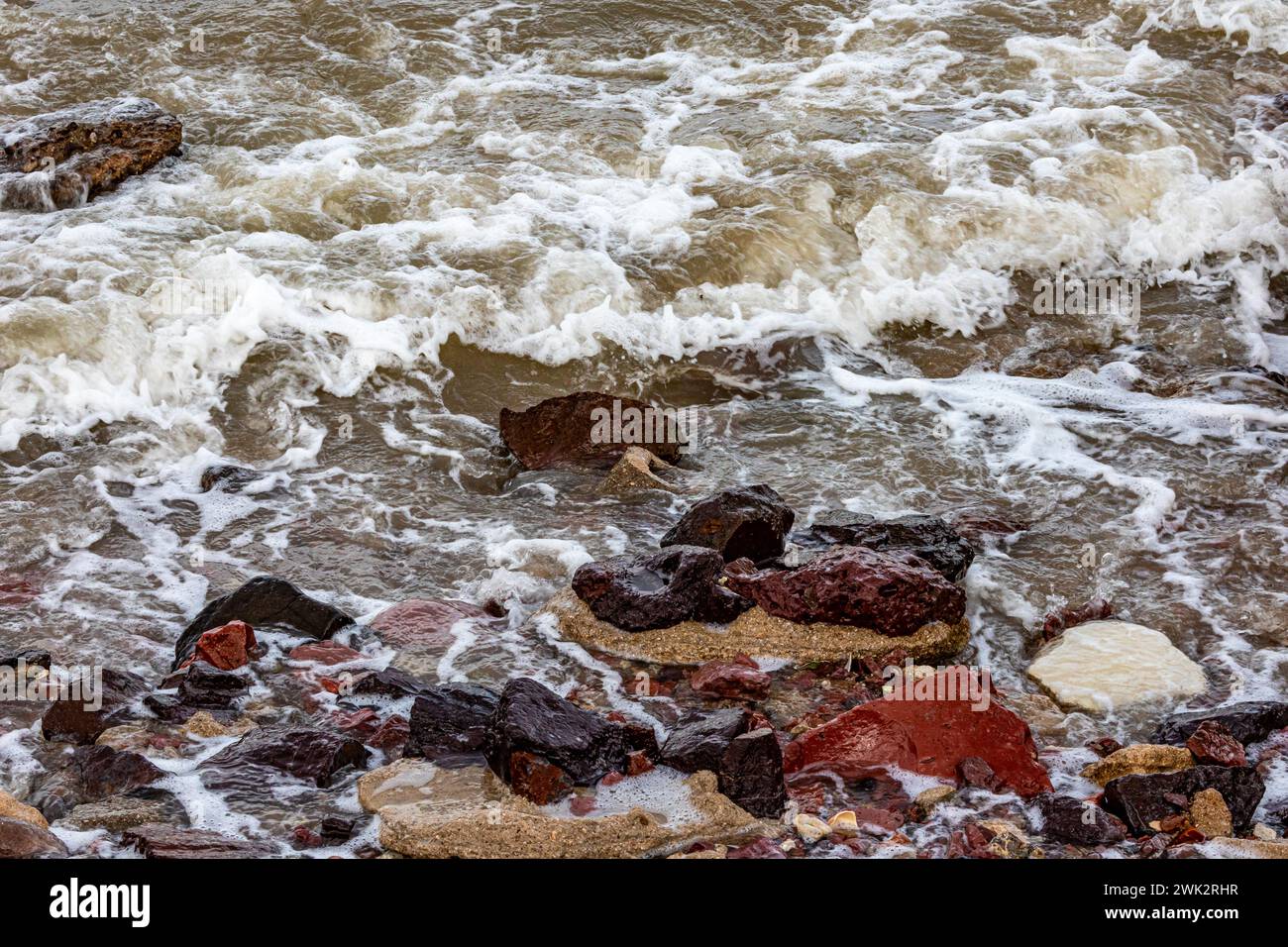 Rocky coastal beach with sea water breaking stones and rocks, waves ...