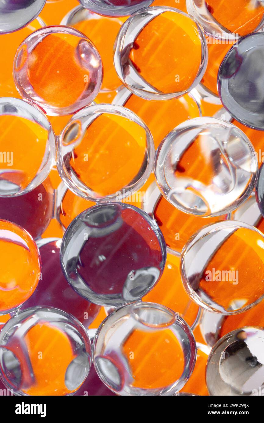 Orange, red and grey translucent crowded spheres composing a colorful ...