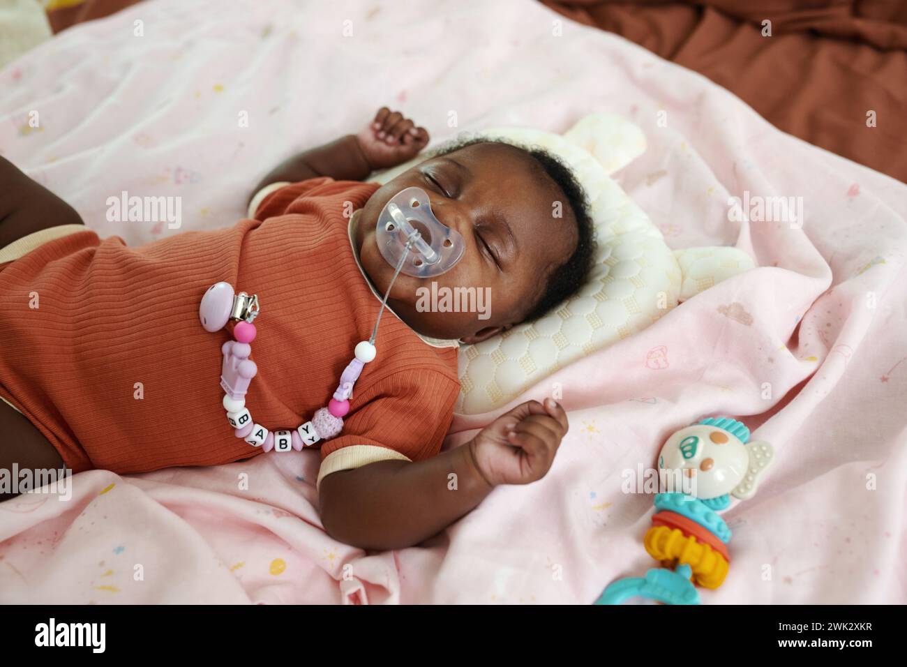 Newborn baby girl sleeping with pacifier in mouth Stock Photo - Alamy