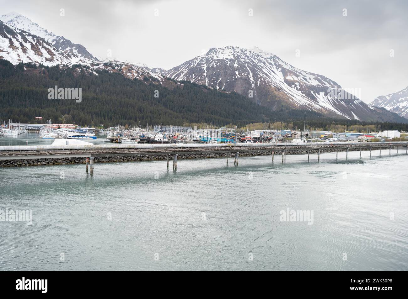 Boats in the Seward Marina with snow capped mountains behind, Alaska ...
