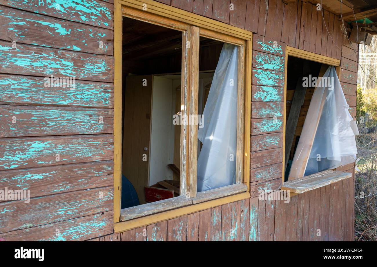 Old wooden gazebo after a break-in with broken windows Stock Photo - Alamy