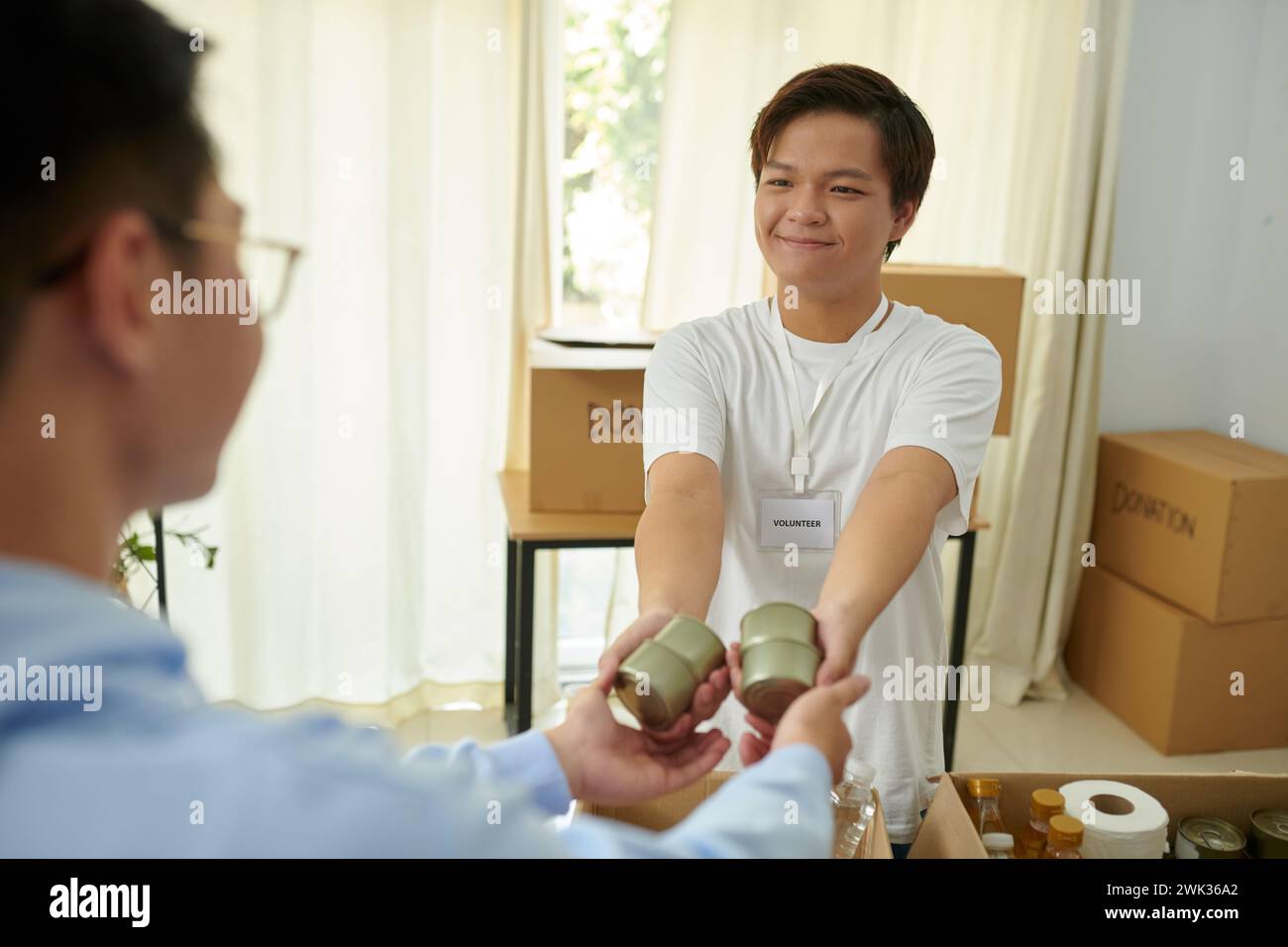 Donating a can hi-res stock photography and images - Alamy
