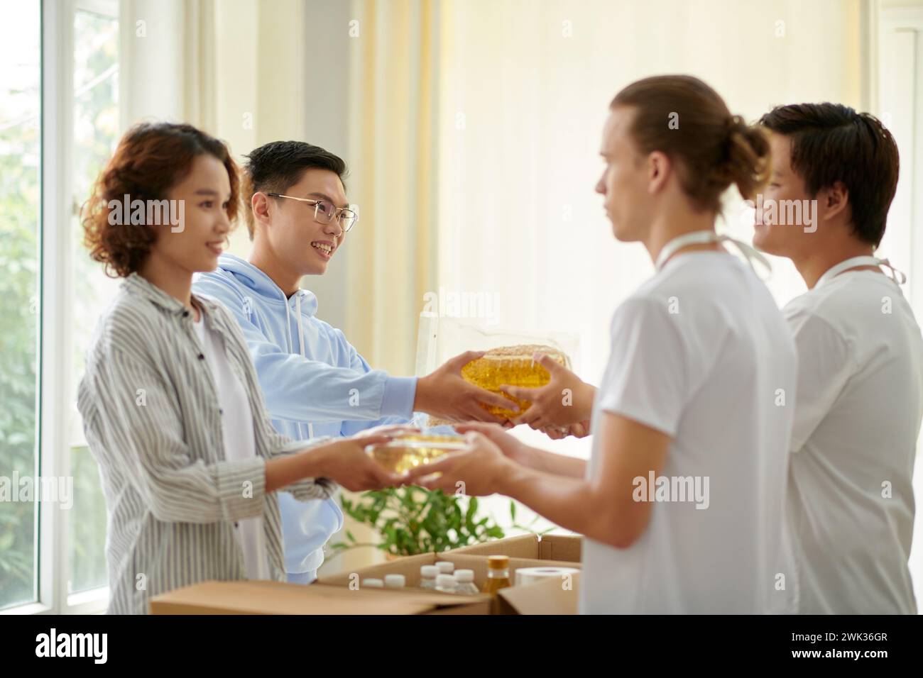 People bringing food to donate to charity organization Stock Photo - Alamy