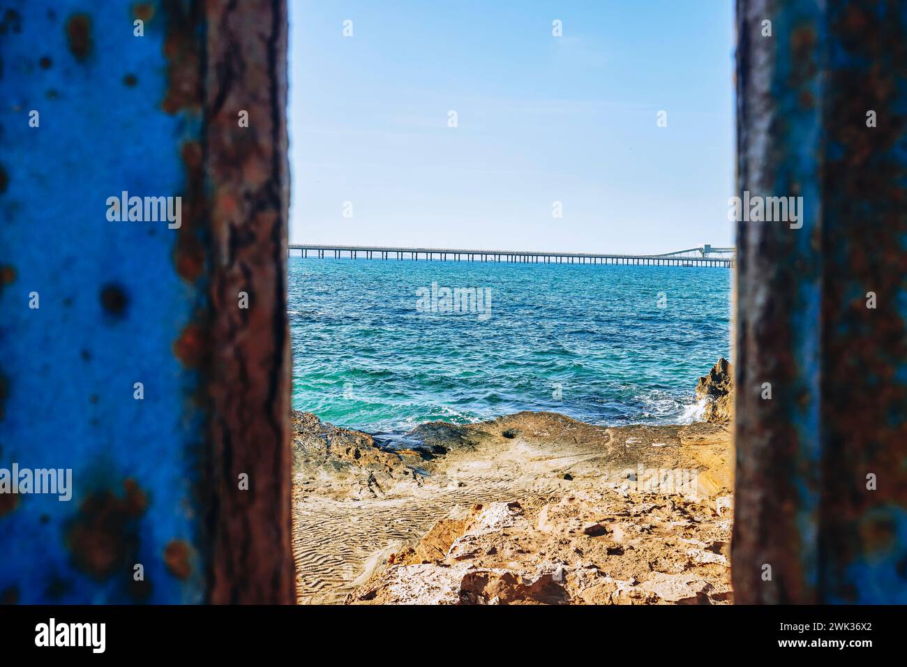 view of ocean against the rocks through window Stock Photo - Alamy