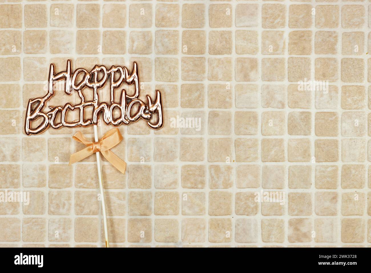 happy birthday text concept with ribbon isolated on tiles background ...
