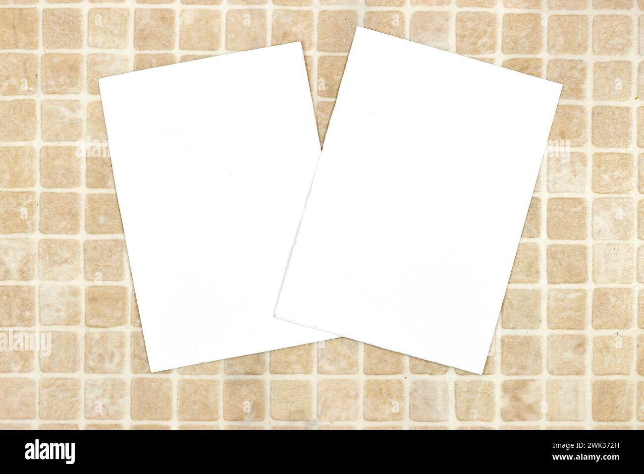 Two paper invitation cards on tiles background with copy space for card ...