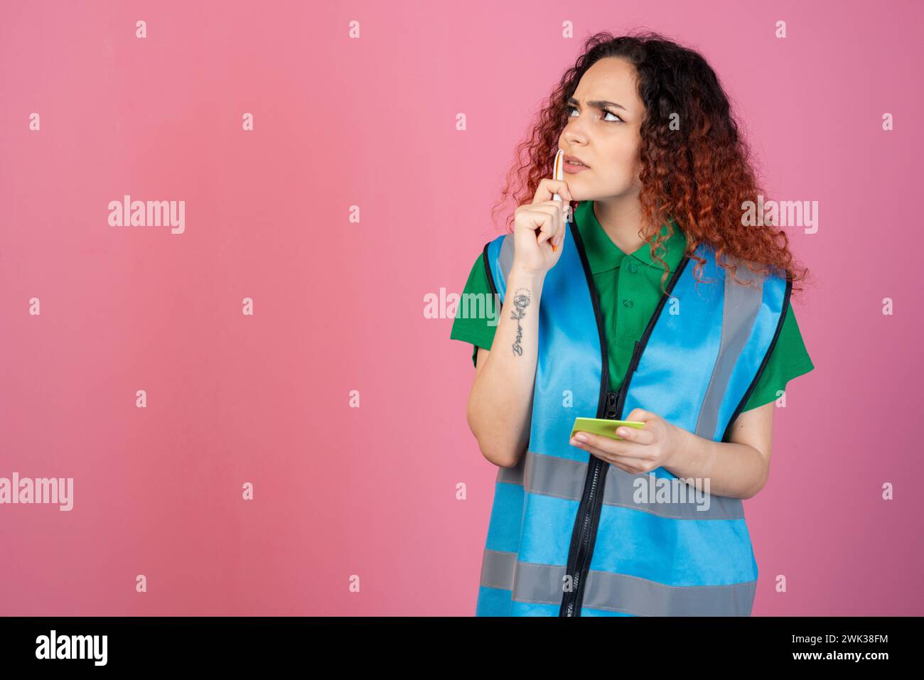 Attractive, female paramedic wearing vest, posing indoors, holding ...