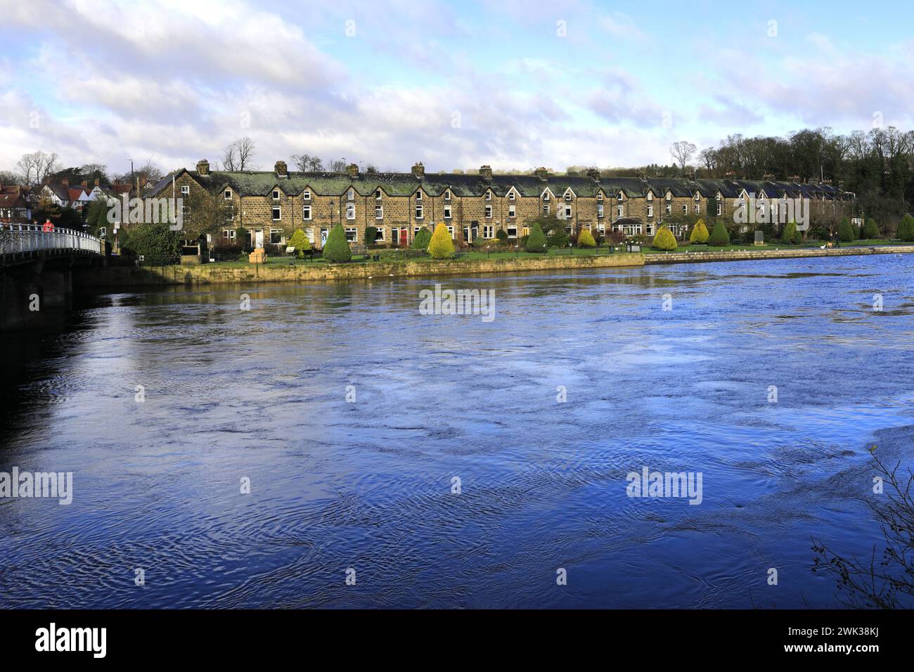 Housing next to the road bridge over the river Wharfe, Otley town ...
