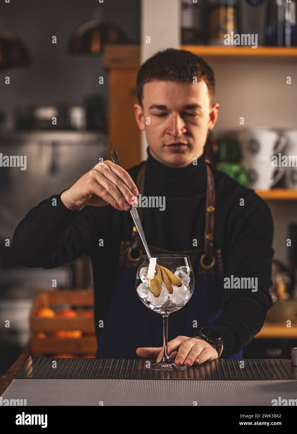 Professional bartender decorates cocktail glass. Barman at work Stock ...